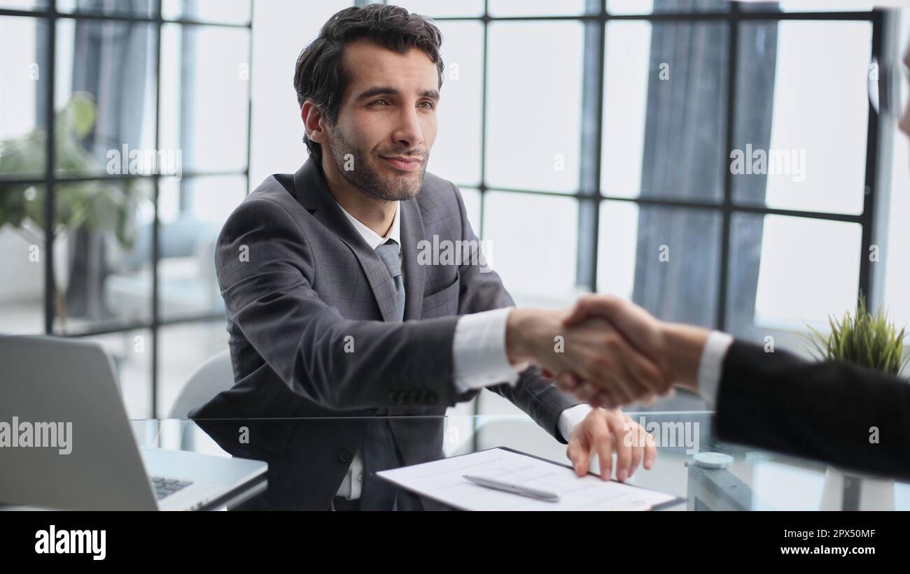 Happy business men giving handshakes after negotiations Stock Photo - Alamy Happy business men giving handshakes after negotiations Stock Photo - Alamy