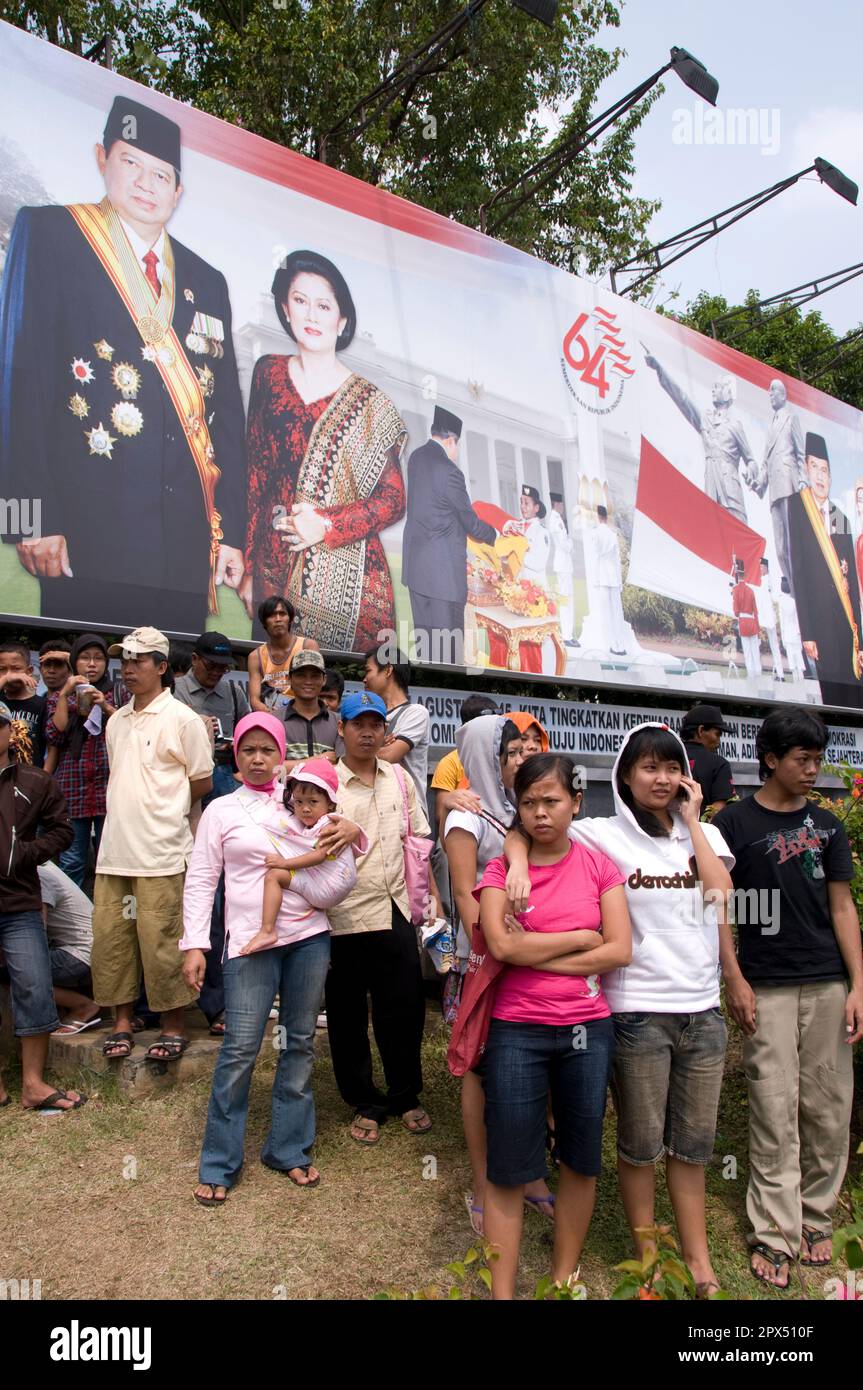 People in front of poster commemorating 64 years of Independance with ...