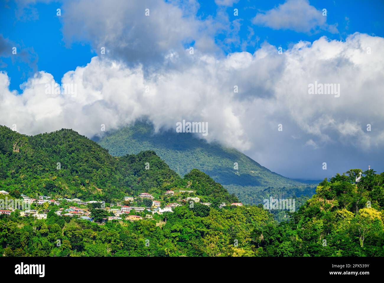 A view of the coast of Dominica and the jungle under a blue sky with ...