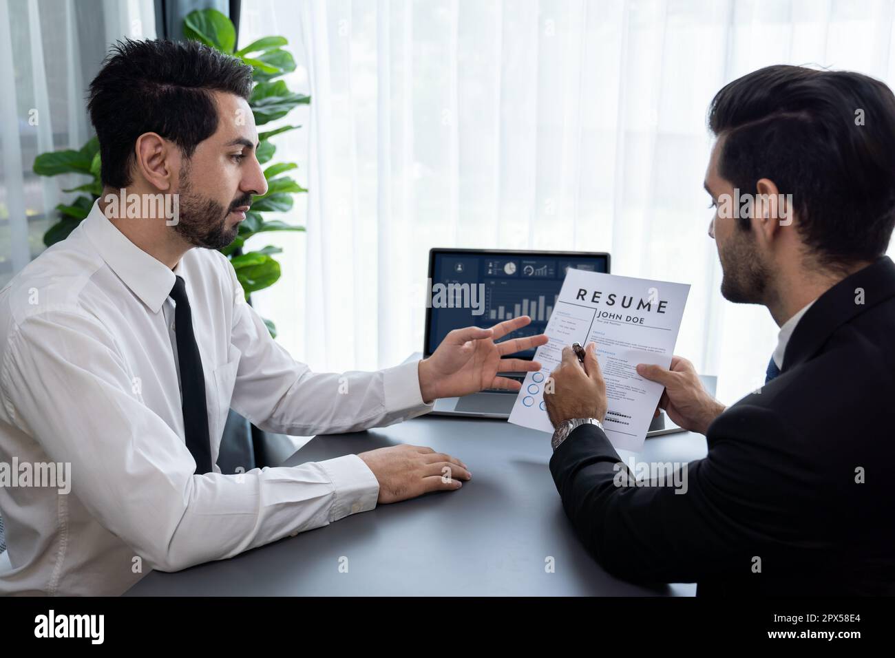 Interviewing job applicant in office with resume paper. Candidate wear ...