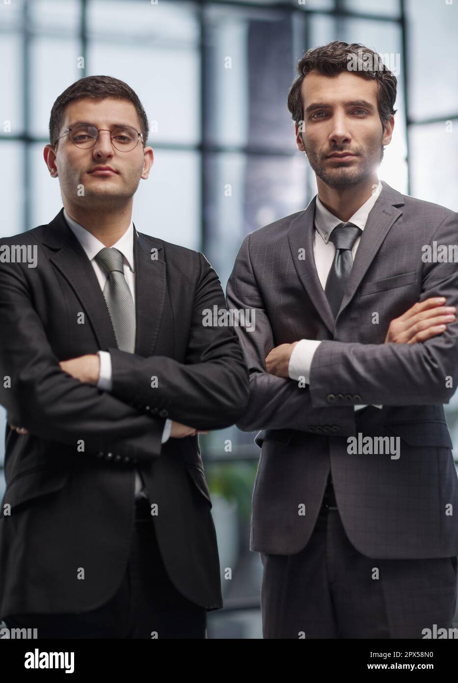Two men business workers standing with arms crossed gesture at office ...