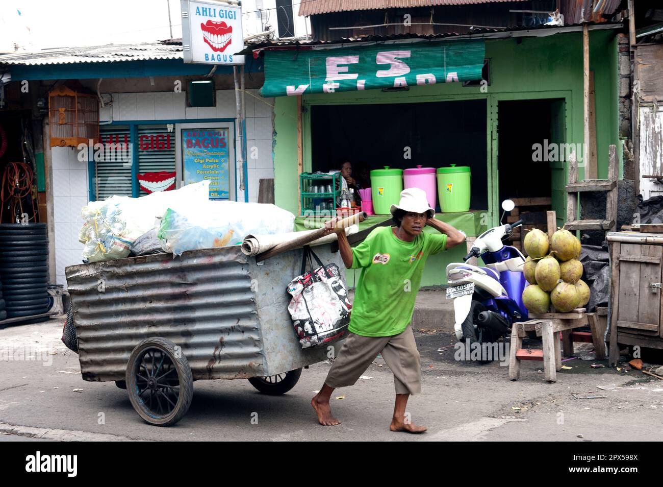 Man pulling garbage collection cart, Manggarai district, Jakarta ...