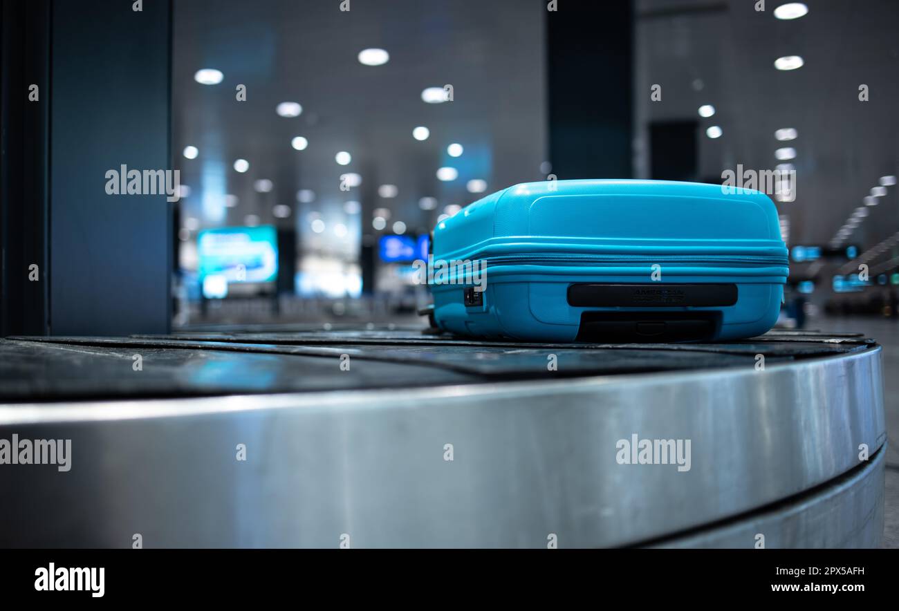 Young woman with her luggage at an international airport, before going ...