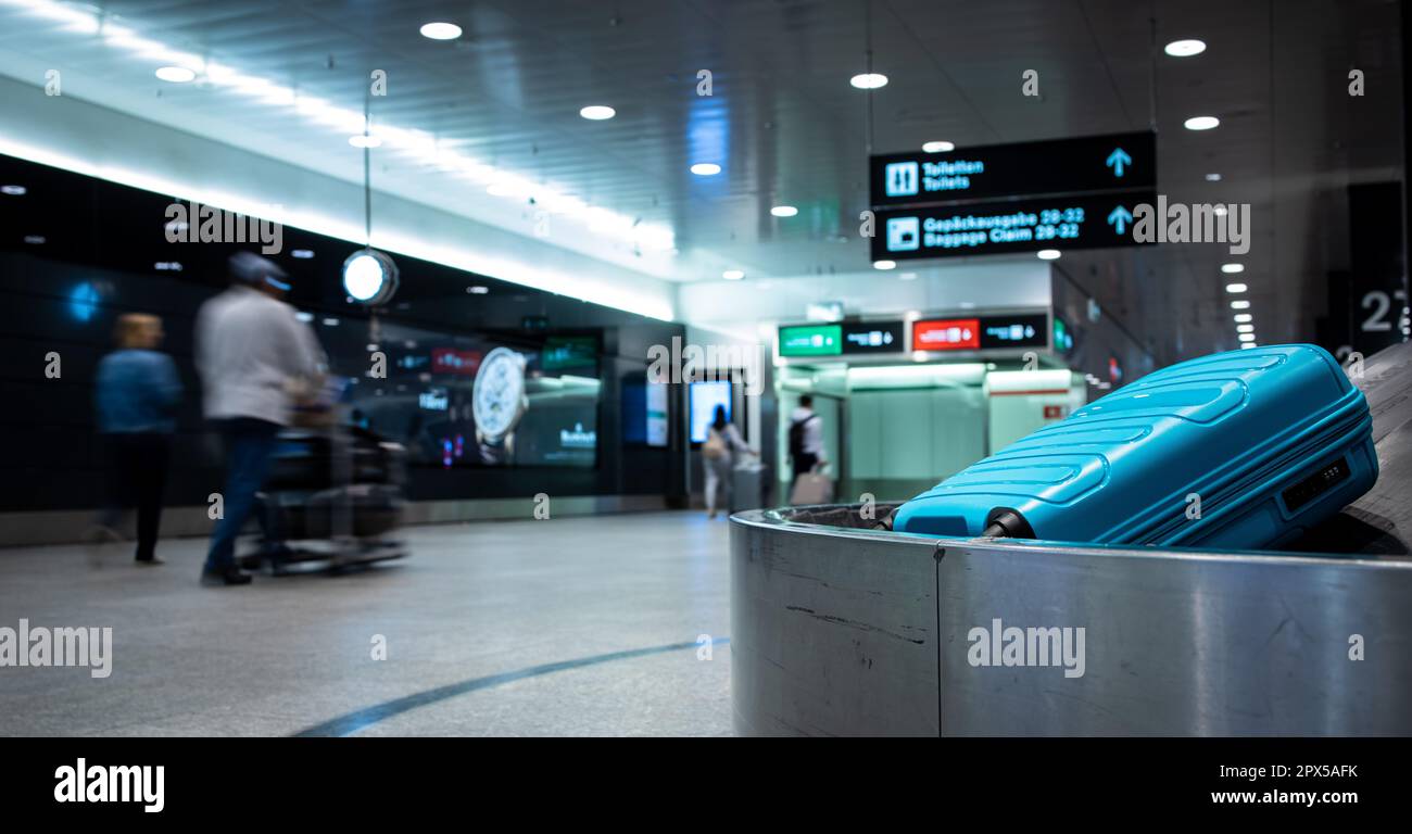 Arrived luggage going around on a conveyor belt waiting to be claimed ...