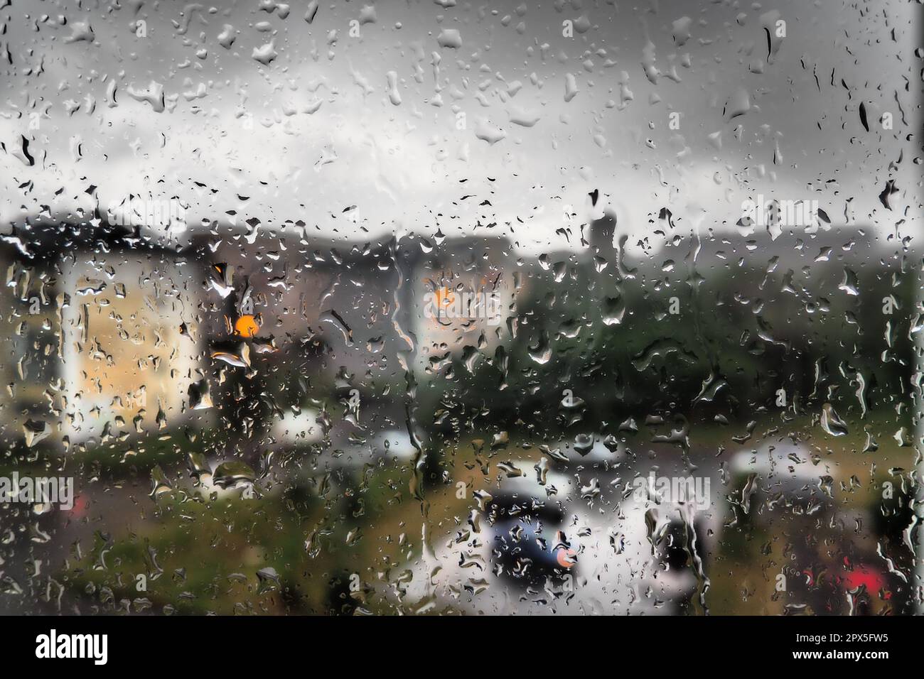 bad weather in the city. Buildings, houses, cars outside the window ...