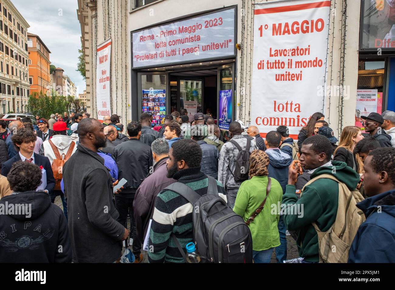 Immigrant workers enter the Brancaccio Theater to watch the event ...