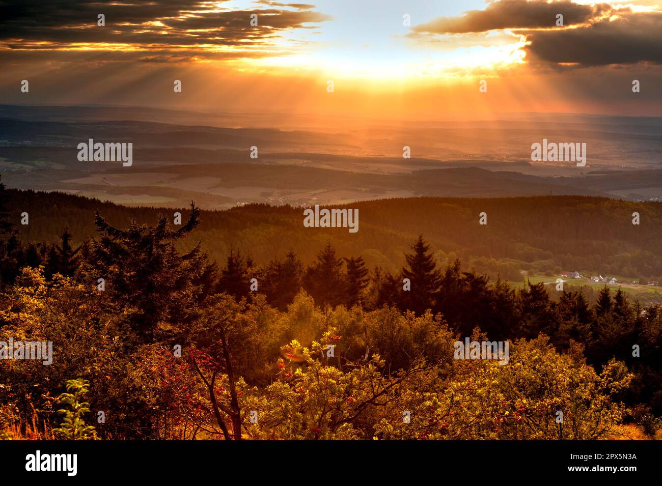 Sunset or sunrise over low mountain landscape in Hesse with deciduous ...