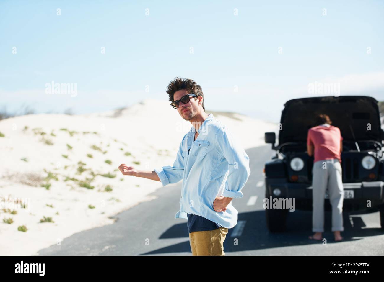 I guess well have to hitchhike. A young man trying to hitch a ride ...