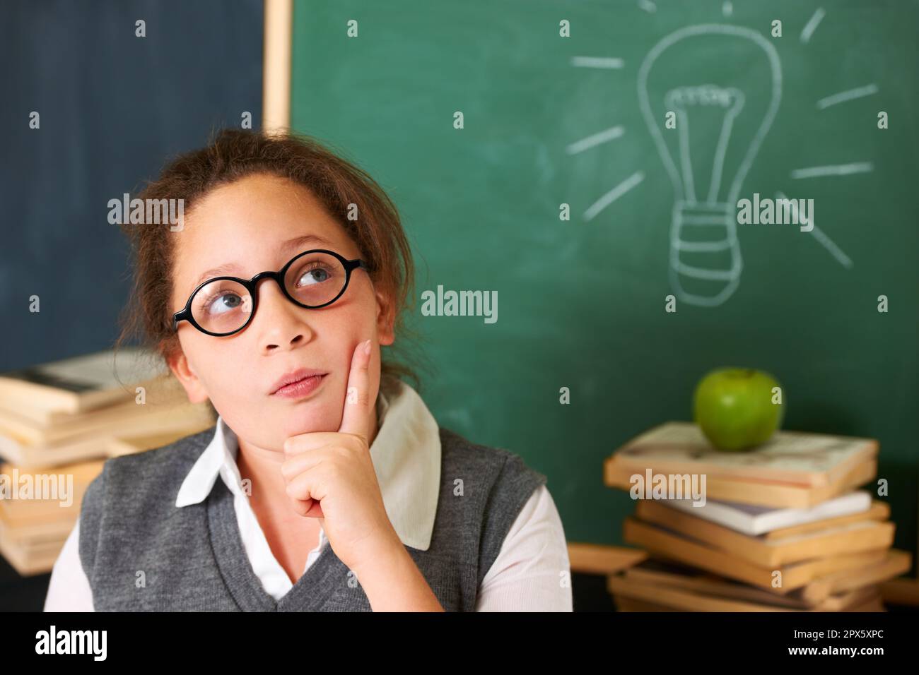 Going through the ideas in her mind. A cute brunette girl deep in ...