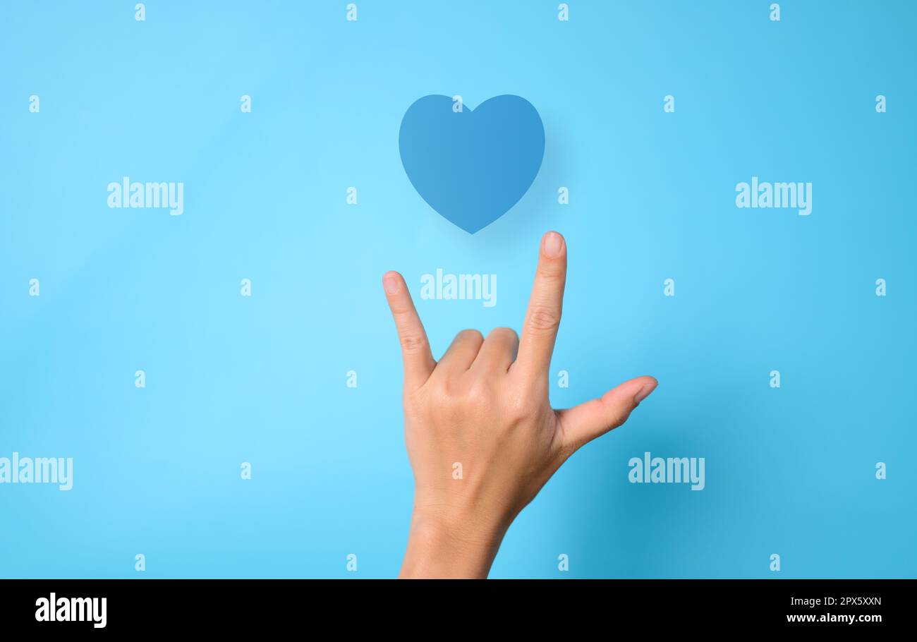 blue hearth icon with blue background and i love you hand Stock Photo ...
