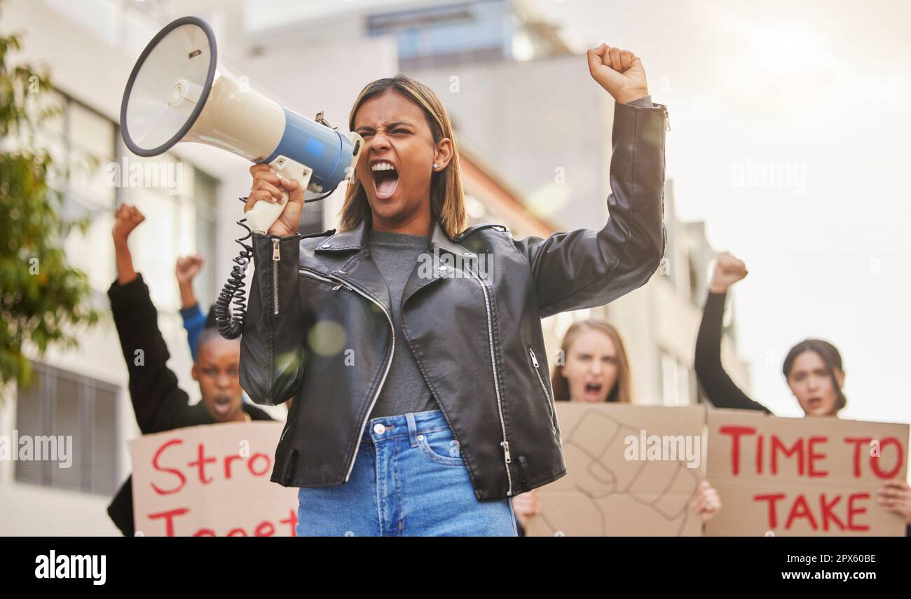 Protest, shouting and woman with megaphone in city marching for gender ...