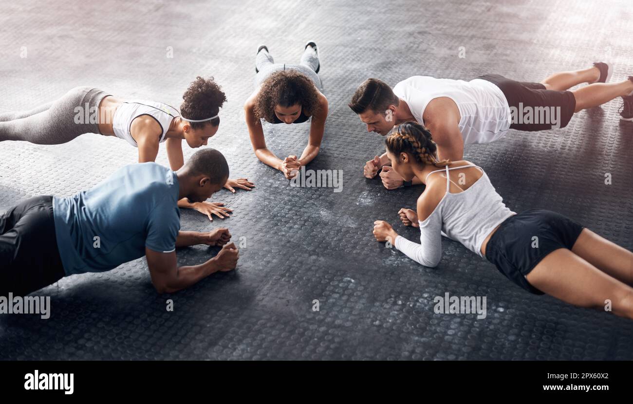 If you can plank you can do anything. a group of young people doing ...