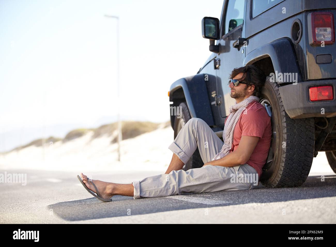 I need a little help out here. A young man waiting for roadside ...