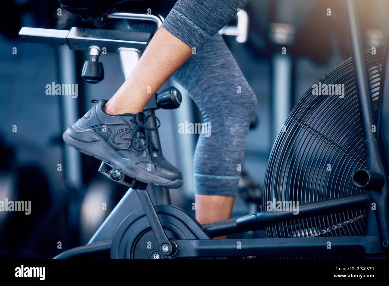 Closeup, fitness and person training, bike and exercise for wellness ...