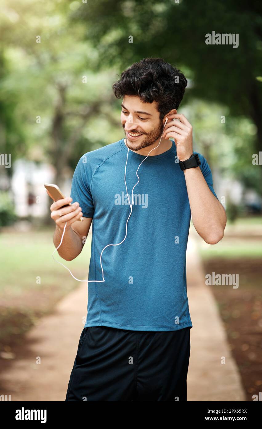This is my favorite song. a sporty young man listening to music while ...