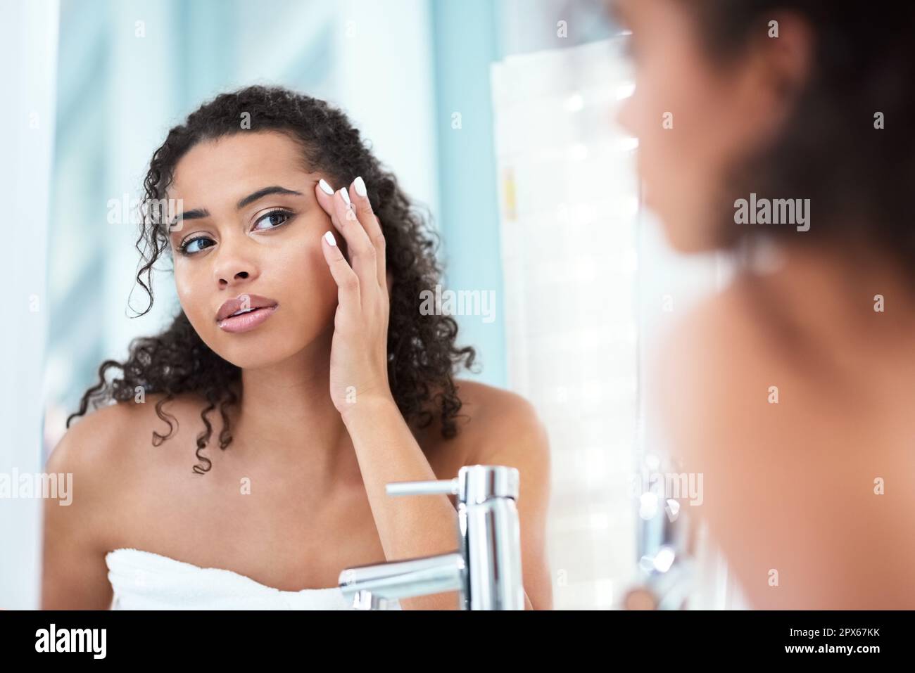 Need something for those fine lines. a beautiful young woman inspecting ...