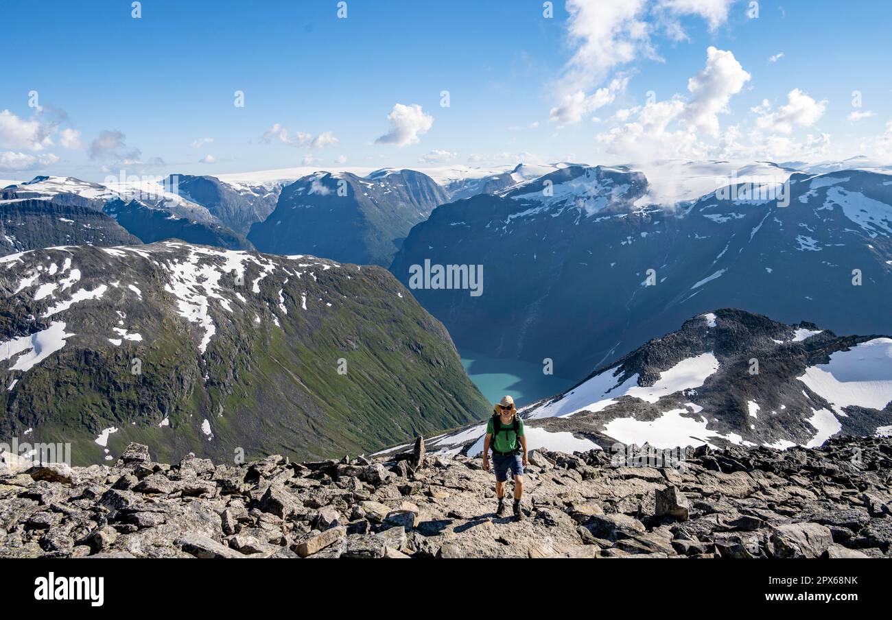 Hikers climbing to the top of Skala, view of mountains with remnants of ...