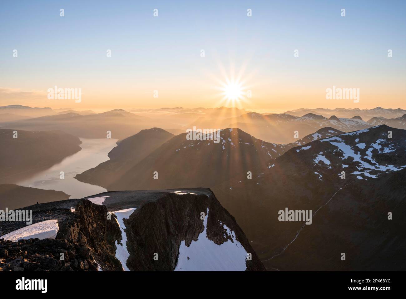 View of mountains and fjord Faleidfjorden, sun star at sunset, summit ...