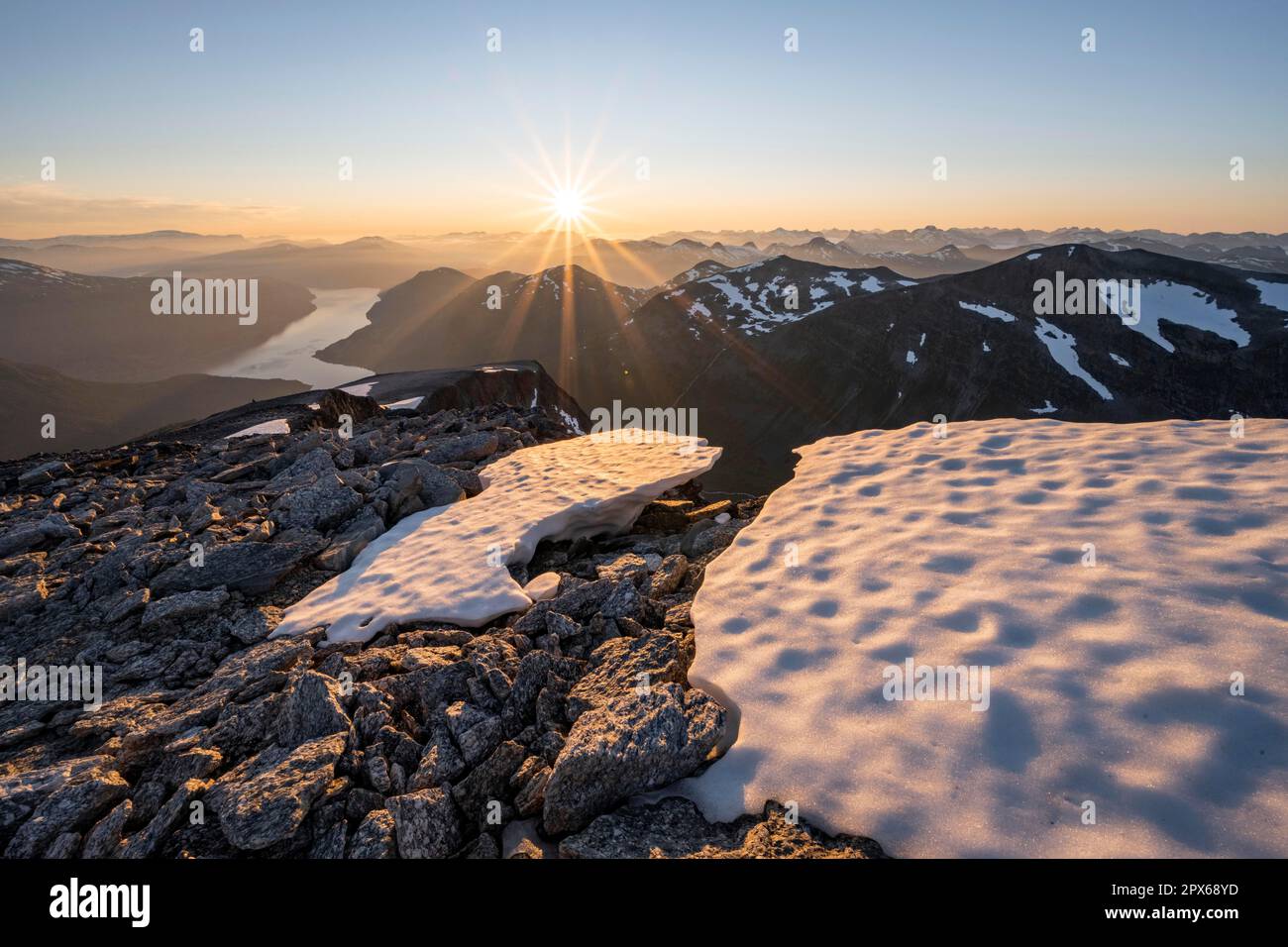 View of mountains and fjord Faleidfjorden, sun star at sunset, summit ...