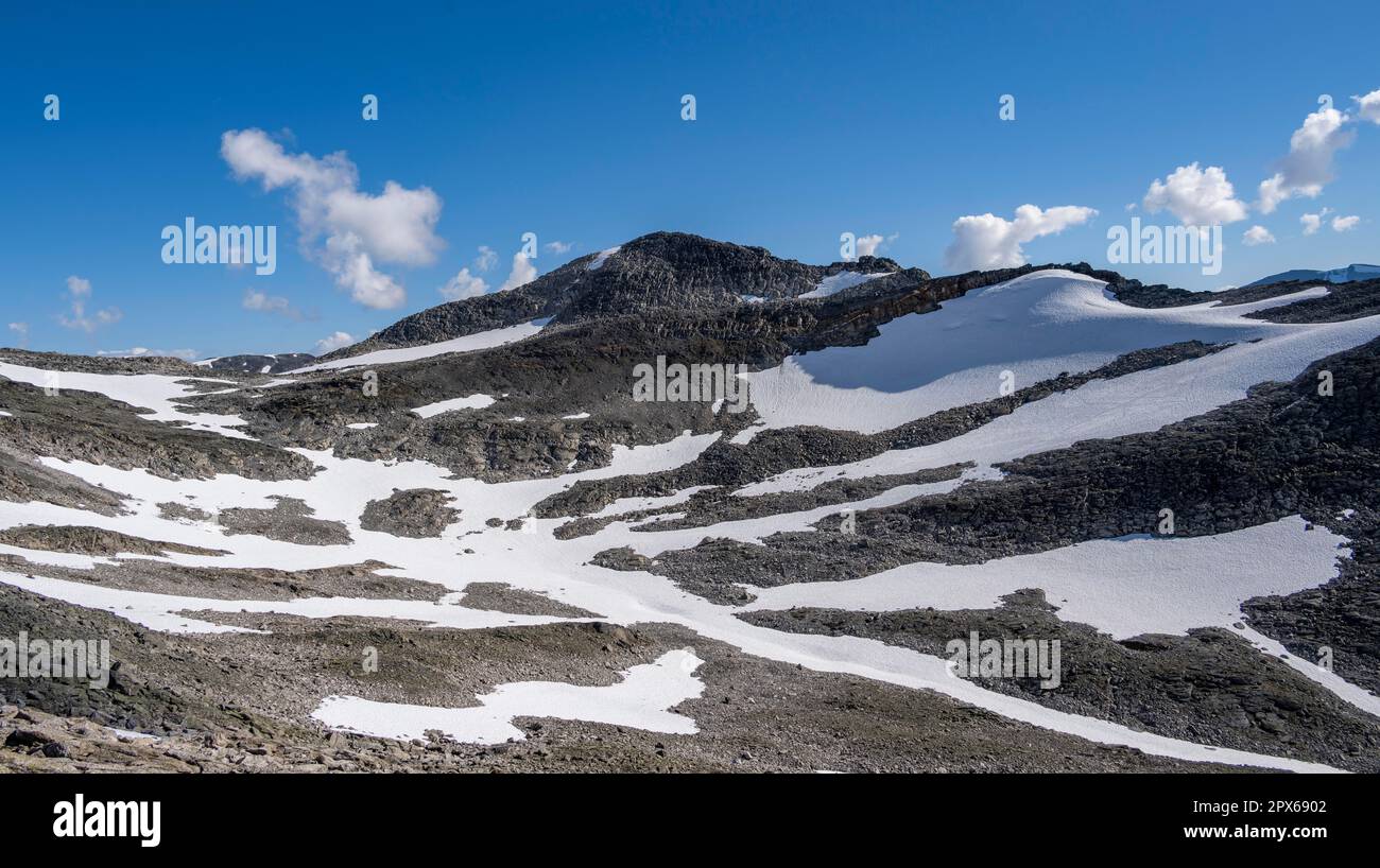 Climbing to the top of Skala, rocky summit with remnants of snow, Loen ...