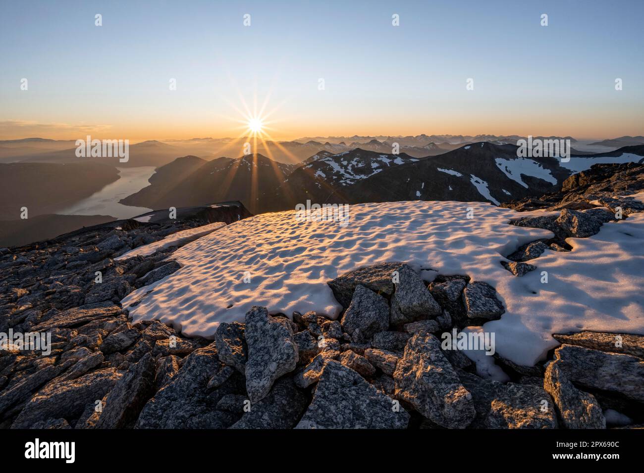 View of mountains and fjord Faleidfjorden, sun star at sunset, summit ...