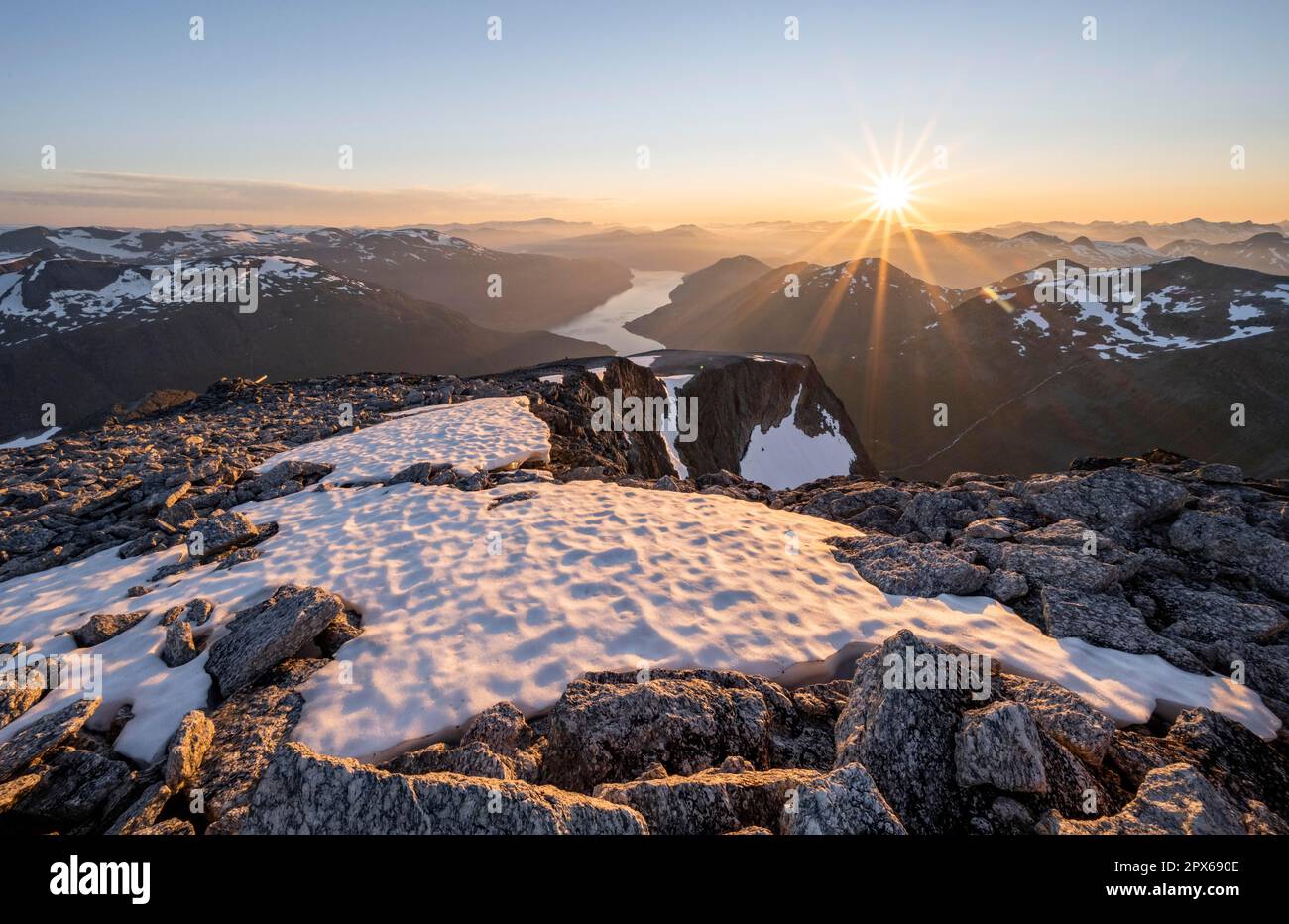 View of mountains and fjord Faleidfjorden, sun star at sunset, summit ...