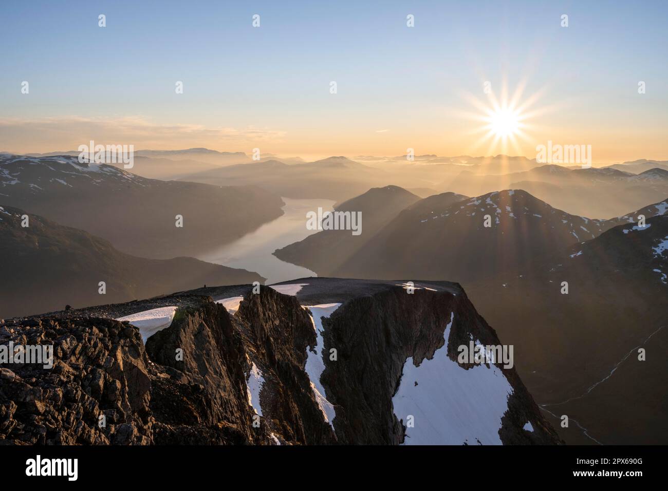 View of mountains and fjord Faleidfjorden, sun star at sunset, summit ...