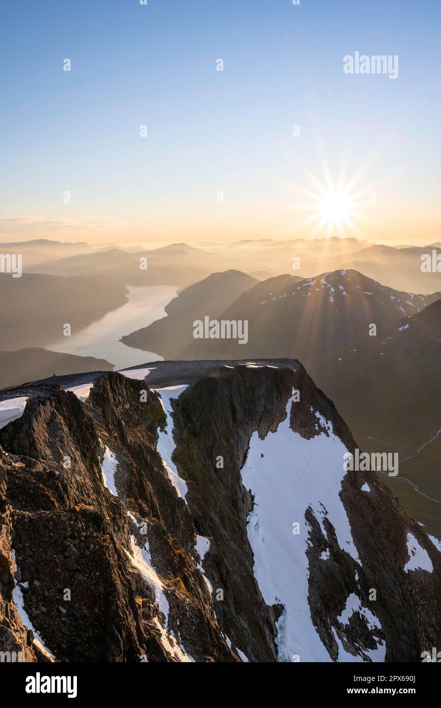 View of mountains and fjord Faleidfjorden, sun star at sunset, summit ...