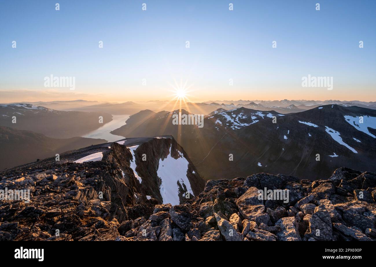 View of mountains and fjord Faleidfjorden, sun star at sunset, summit ...