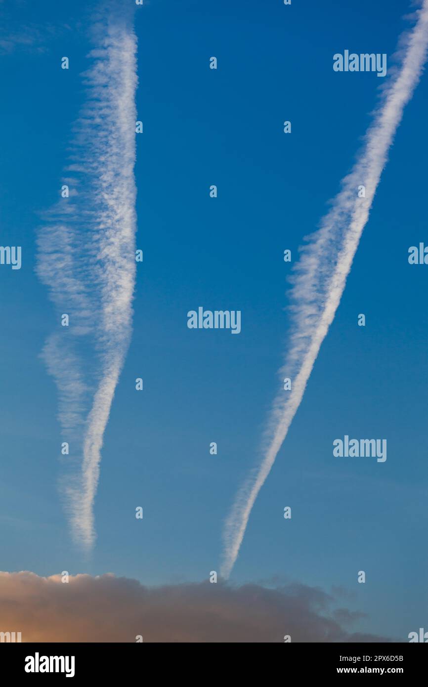 Condensation trails road crossings in the sky Stock Photo - Alamy