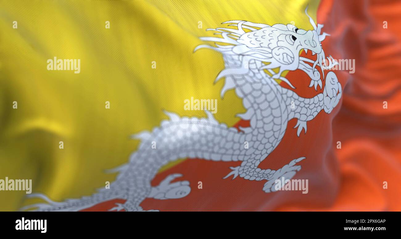 Close-up view of the Bhutan national flag waving in the wind. The ...