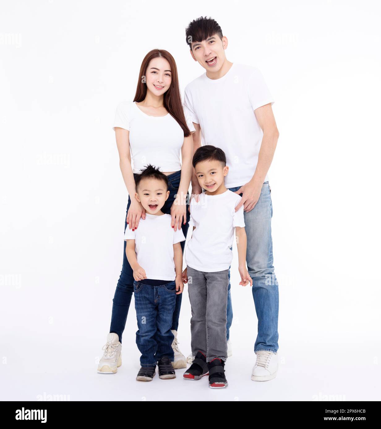 Happy Asian family standing together on white background Stock Photo ...