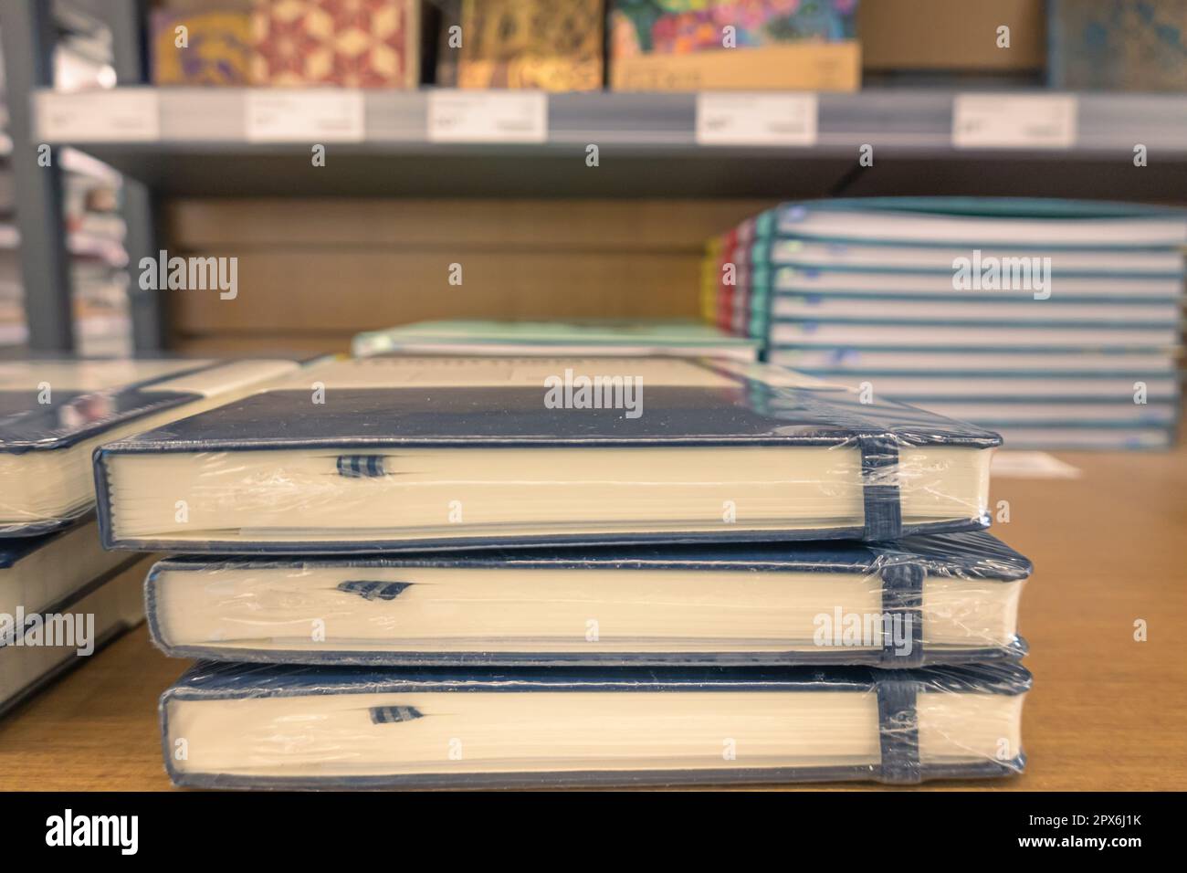 Stack of black notebooks on display Stock Photo - Alamy