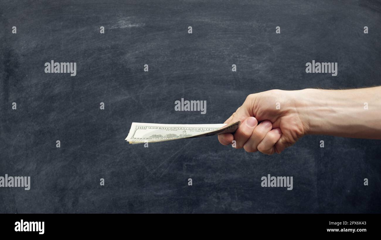 Hand gesture foreign currency offering dollar Stock Photo - Alamy