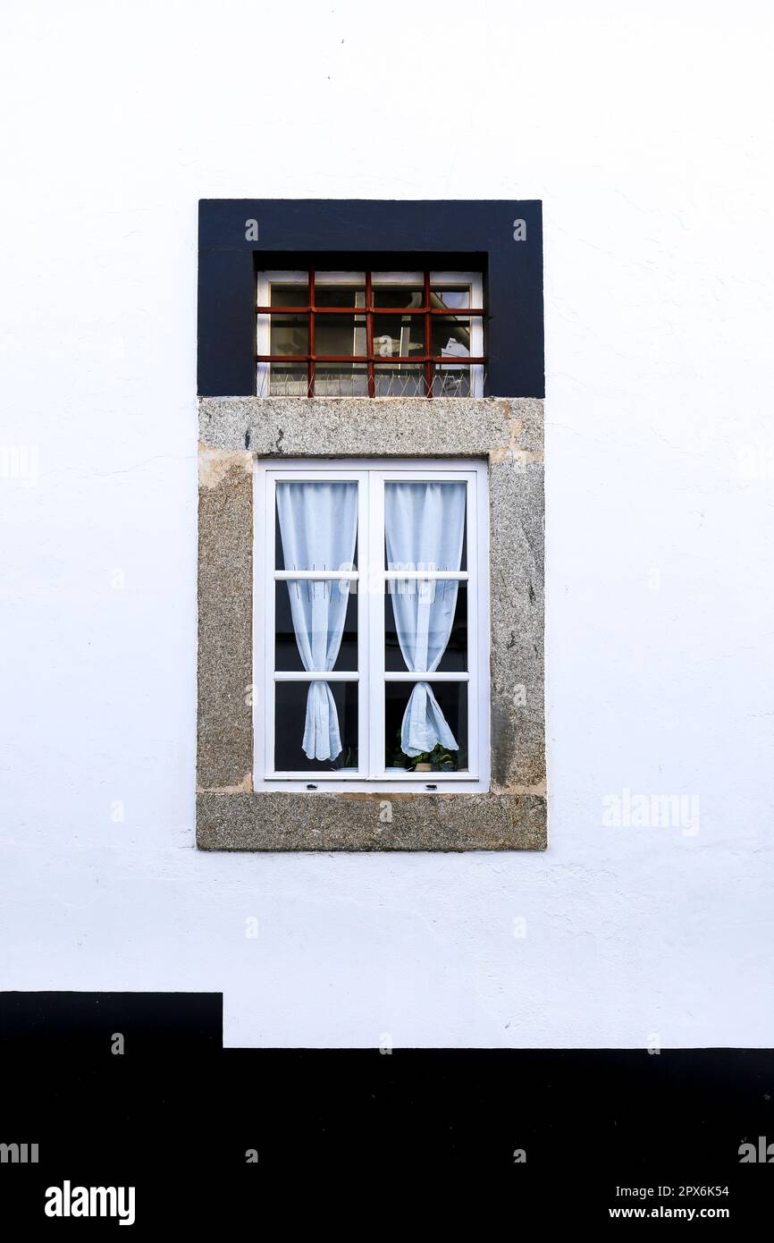 Typical Portuguese facade with White wooden window and curtain on ...
