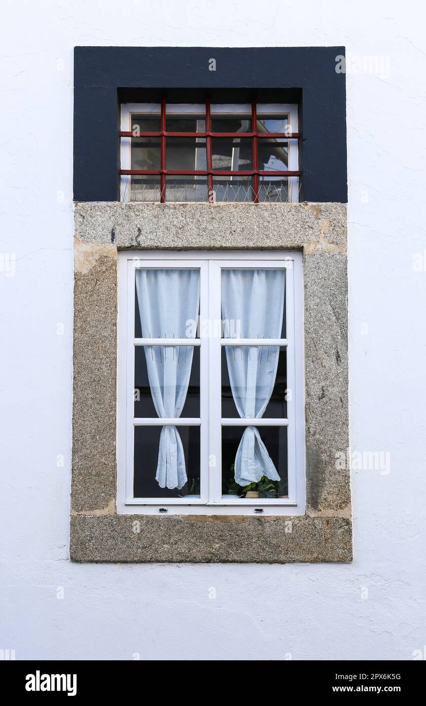 Typical Portuguese facade with White wooden window and curtain on ...