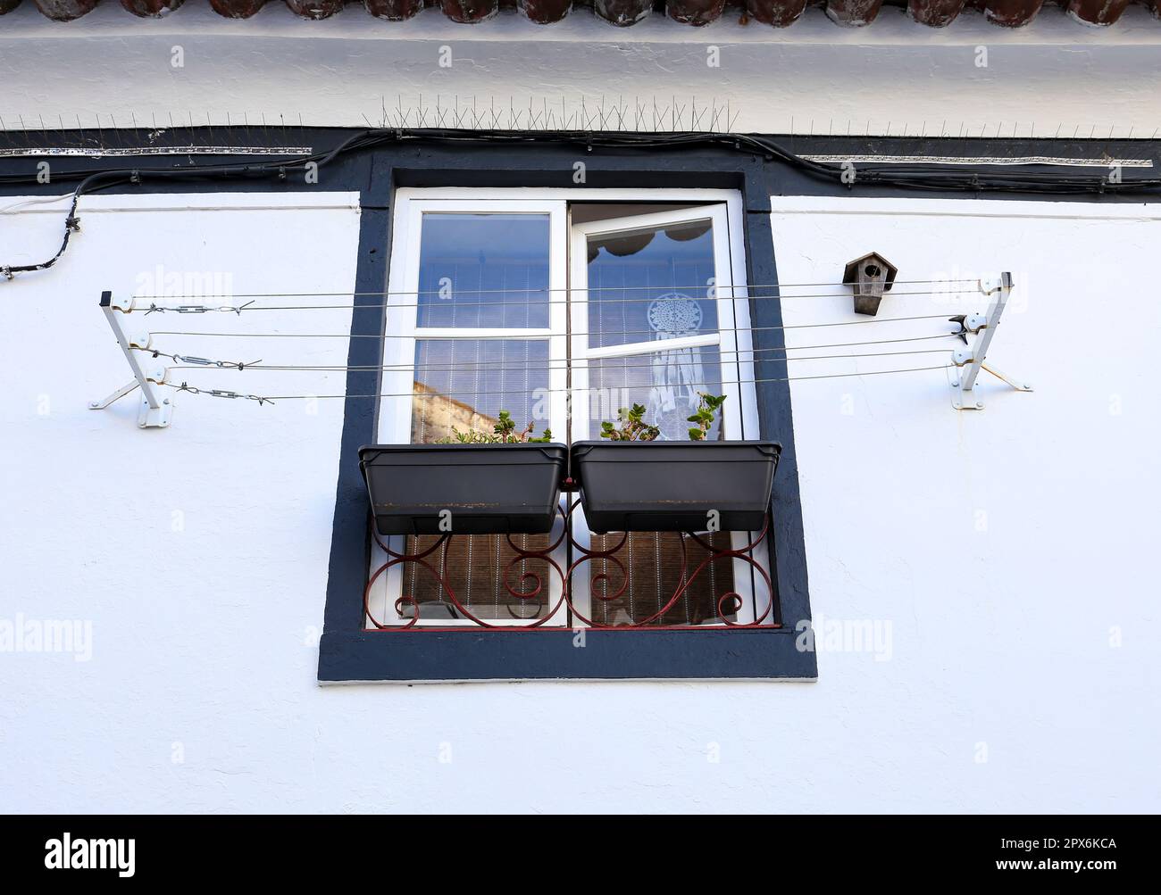 Typical Portuguese facade with window and clothesline in Evora town ...