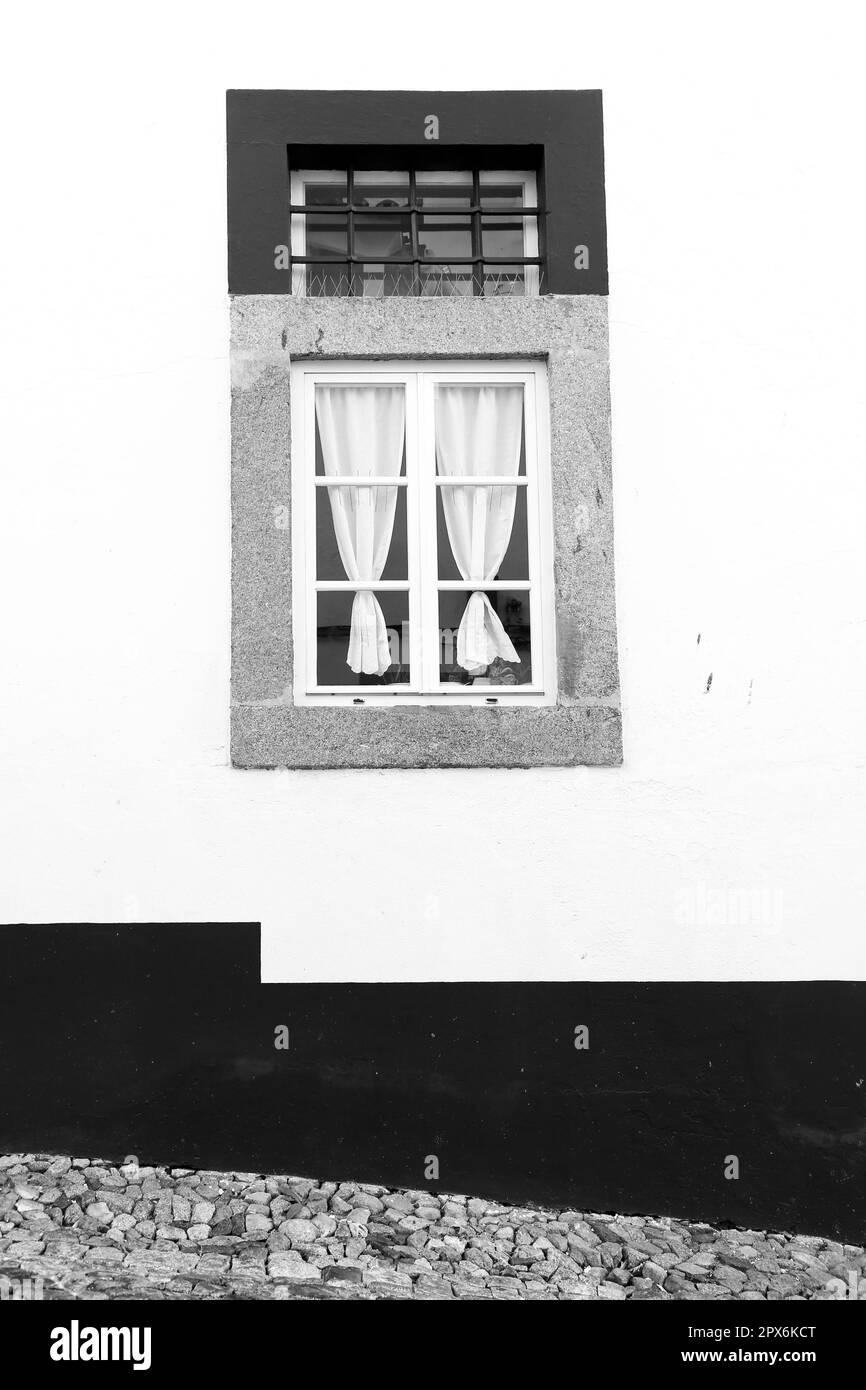 Typical Portuguese facade with White wooden window and curtain on ...