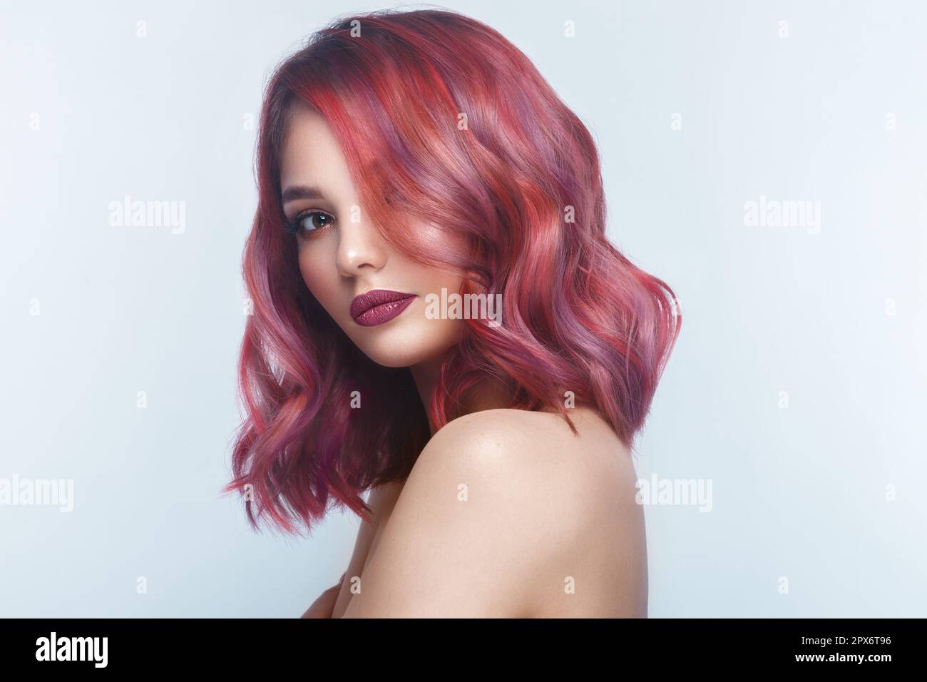 Beautiful girl with multi-colored hair and classic make-up and ...