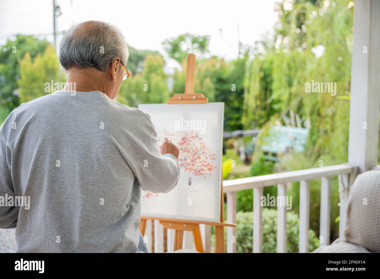 Lifestyle artist. Senior old man painting picture artwork using brush ...
