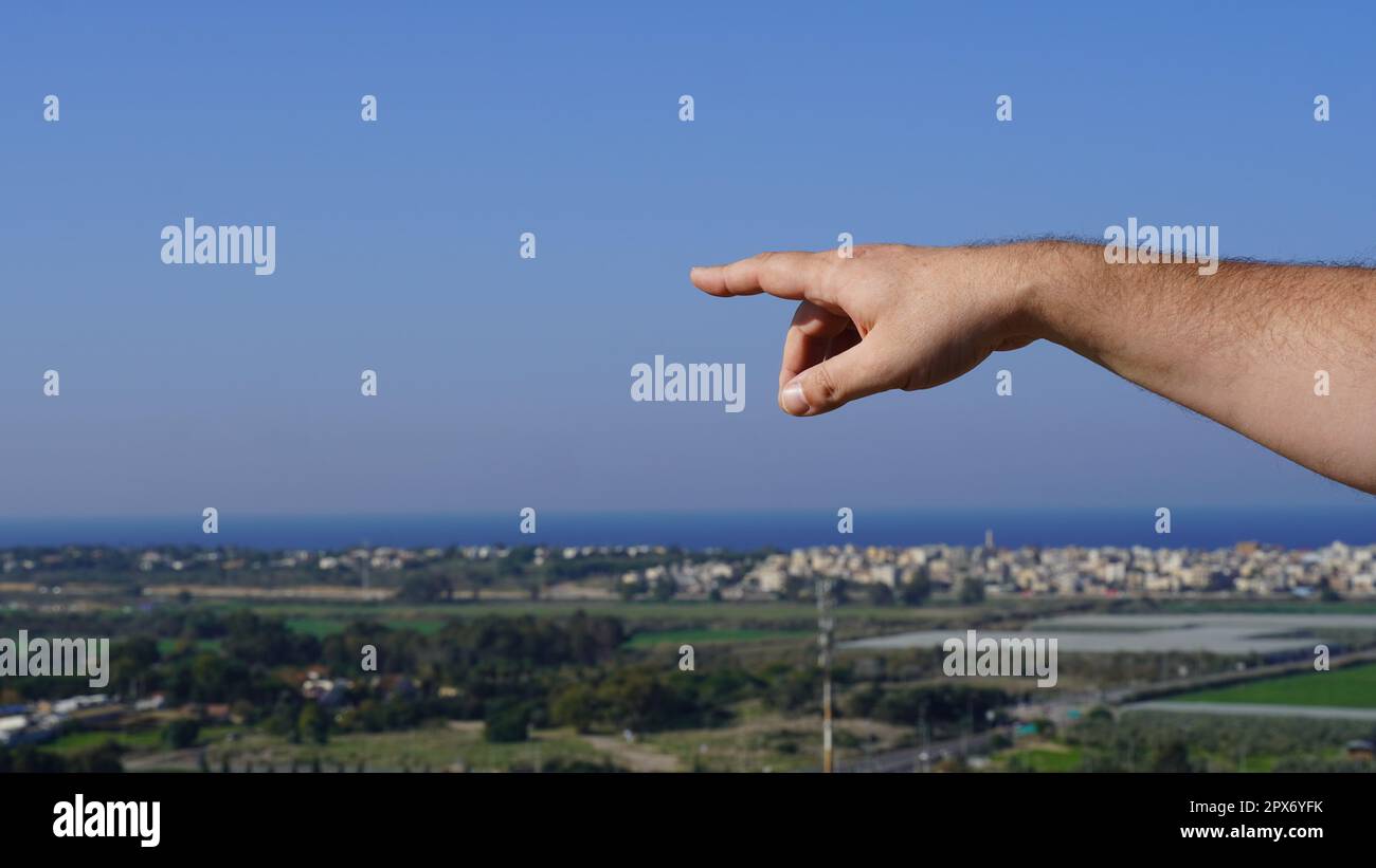 Tour guide's hand pointing to some object Stock Photo - Alamy