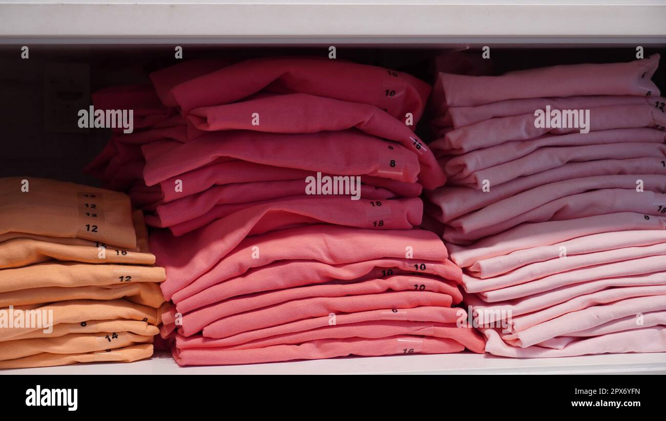 Stack of cloth different colors and sizes on the shelves in a clothes ...