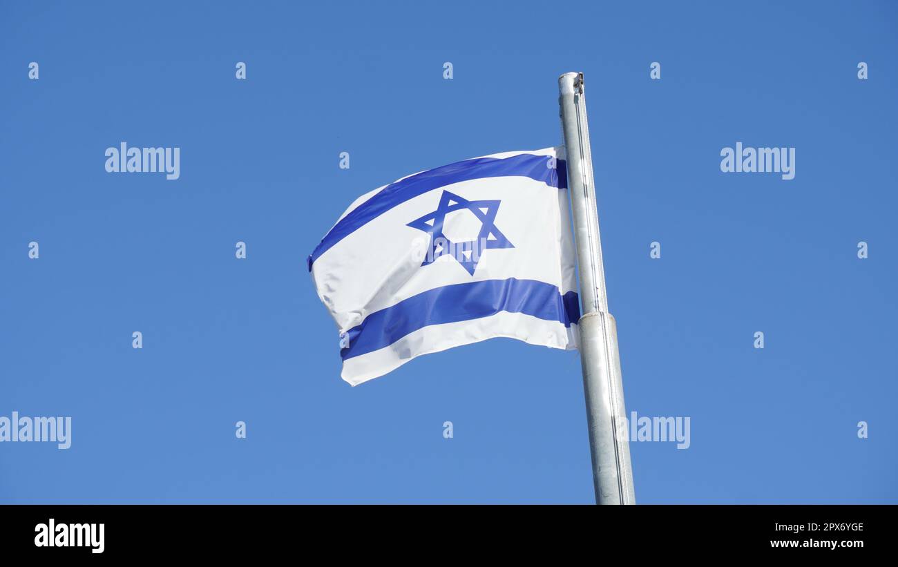 Israeli flag weaving in the wind against bright skies Stock Photo - Alamy