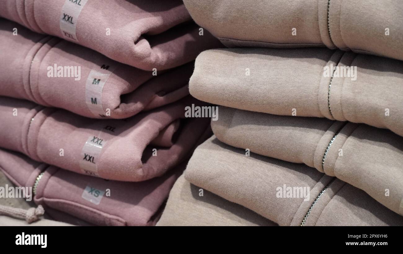 Stack of cloth different colors and sizes on the shelves in a clothes ...