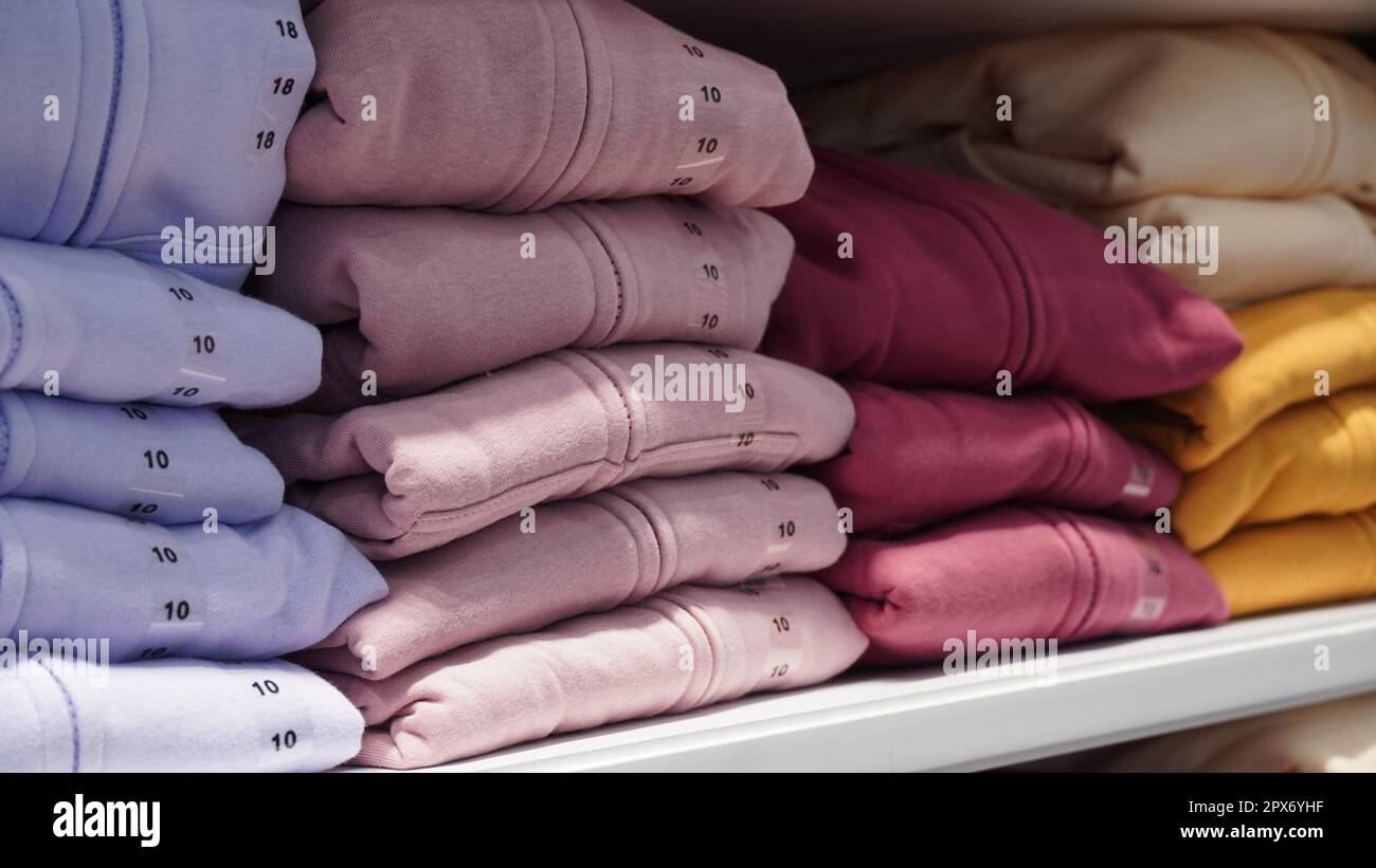 Stack of cloth different colors and sizes on the shelves in a clothes ...