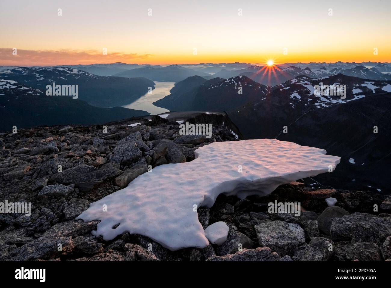View of mountains and fjord Faleidfjorden, sun star at sunset, summit ...