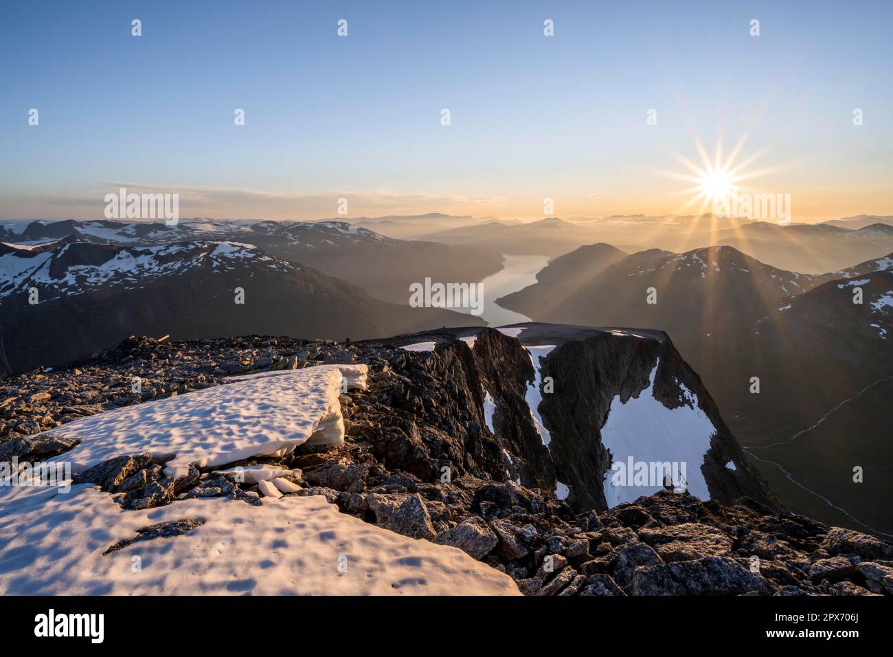 View of mountains and fjord Faleidfjorden, sun star at sunset, summit ...