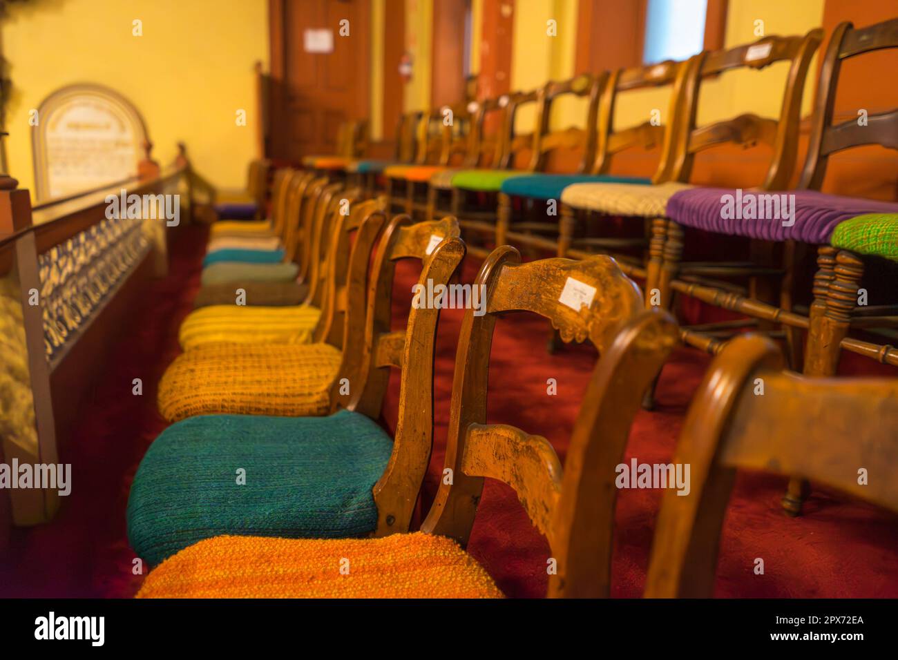 Row colorful wooden chairs hi-res stock photography and images - Alamy