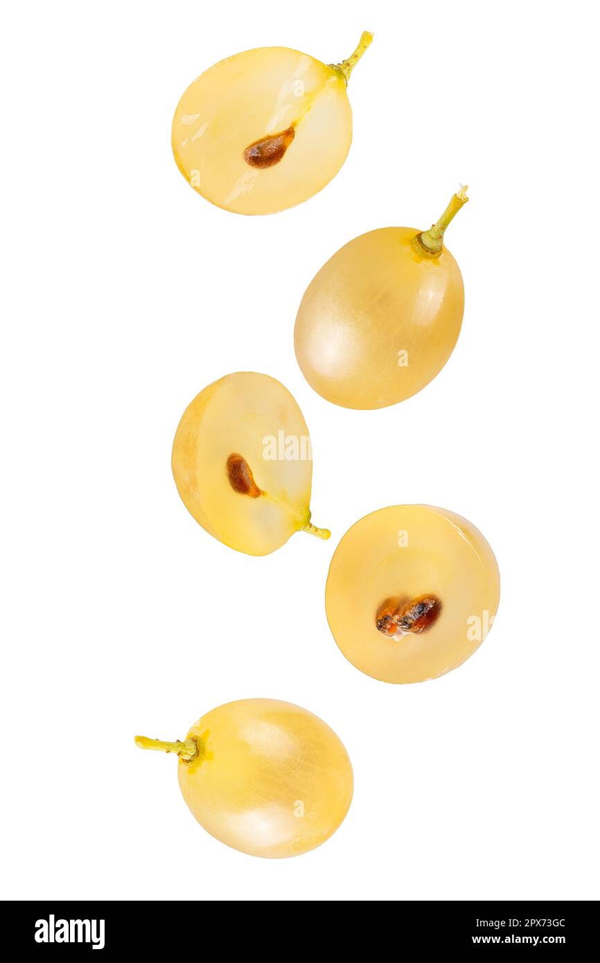 Isolated flying grapes. Five whole and sliced grape fruits falling on ...