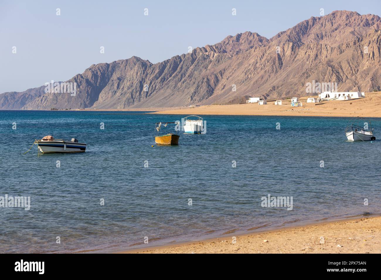 View of Red Sea and boats moored in the port, Dahab, Egypt. Dahad is a ...